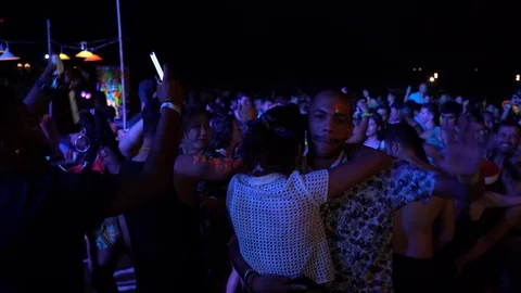 Girls and boys dance on the sandy beach ... | Stock Video | Pond5