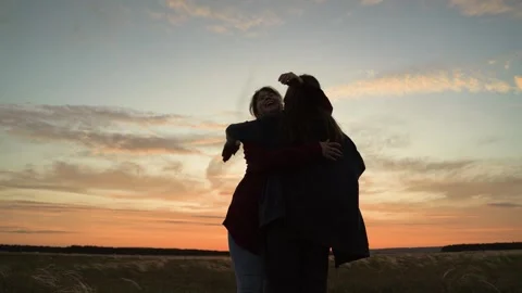 Girls friends hugging at sunset in park,... | Stock Video | Pond5