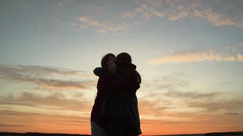 Girls friends hugging at sunset in park,... | Stock Video | Pond5