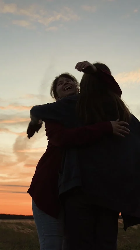Girls friends hugging at sunset in park,... | Stock Video | Pond5