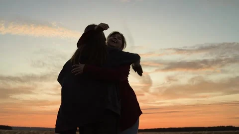 Girls friends hugging at sunset in park,... | Stock Video | Pond5