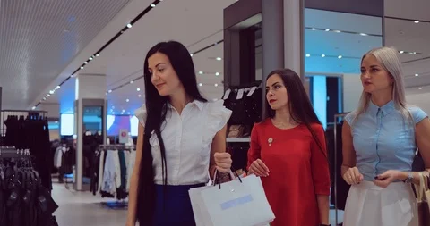 Girls go shopping with shelves with hang... | Stock Video | Pond5