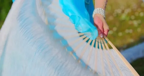 Girl's hand waving a fan-veel on a backg... | Stock Video | Pond5