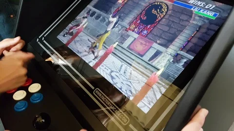 Girls playing violent arcade fighting ga... | Stock Video | Pond5