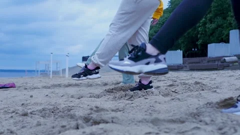 girls shake their legs standing on the s... | Stock Video | Pond5