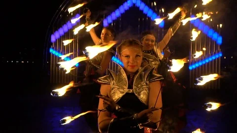 Girls stand in beautiful poses with fire... | Stock Video | Pond5
