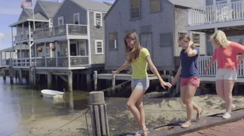 Girls Walk Single File Along Sea Wall On... | Stock Video | Pond5