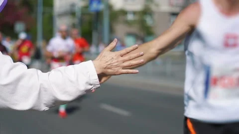 Giving runners high five in slow motion | Stock Video | Pond5