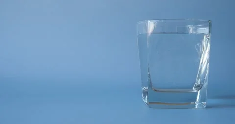 A glass beaker is filled with water on a... | Stock Video | Pond5