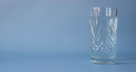 A glass beaker is filled with water on a... | Stock Video | Pond5