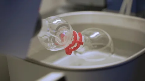 Glass beaker spinning in water in scienc... | Stock Video | Pond5