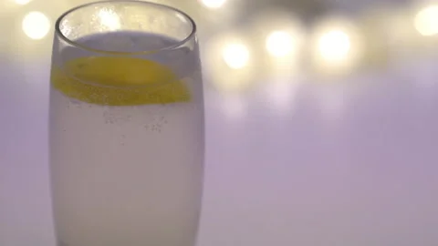 Glass cup with sparkling water and lemon... | Stock Video | Pond5