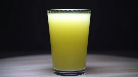 A glass with a dissolving tablet rotates... | Stock Video | Pond5