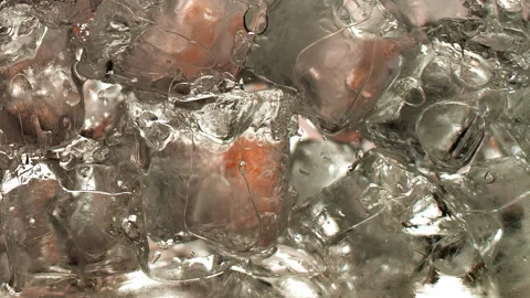 A glass full of ice cubes gradually bein... | Stock Video | Pond5
