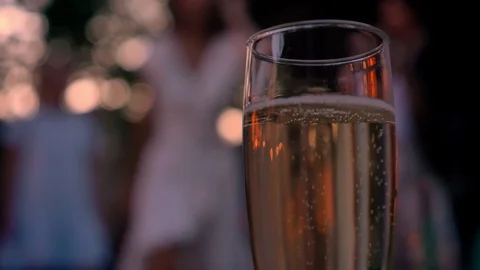 Glass of sparkling champagne, dancing pe... | Stock Video | Pond5