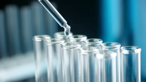 Glass test tubes in laboratory with pipe... | Stock Video | Pond5