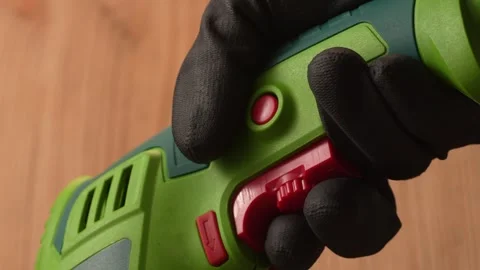 Gloved Hand Gripping Drill Handle and Bu... | Stock Video | Pond5