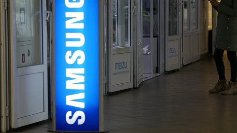 Glowing blue SAMSUNG signboard in shoppi... | Stock Video | Pond5