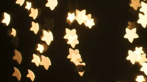 Glowing star shape lights overlay on bla... | Stock Video | Pond5