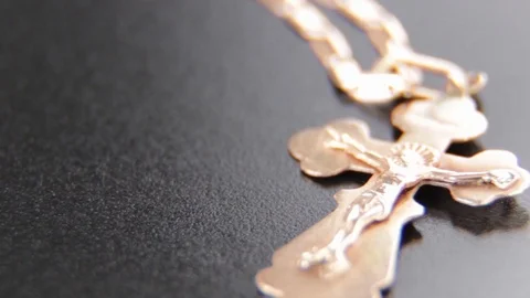 Gold cross on a chain on a black backgro... | Stock Video | Pond5