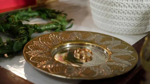 Gold wedding rings on a plate during a c... | Stock Video | Pond5