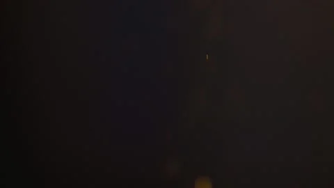 Golden ember sparks floating upward dark... | Stock Video | Pond5