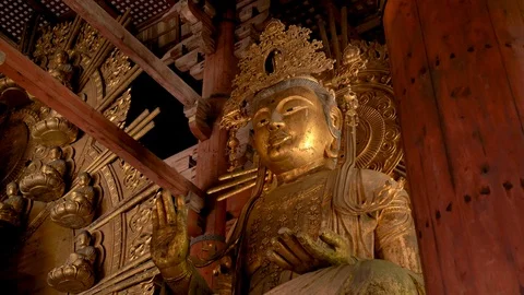 golden god statue watching at prayers bl... | Stock Video | Pond5