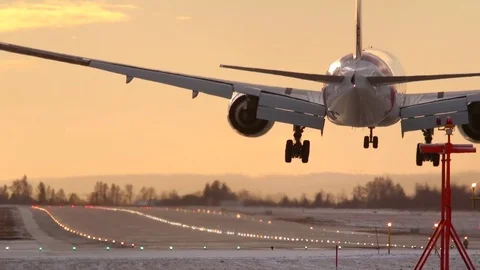 golden hour airplane landing rear view | Stock Video | Pond5