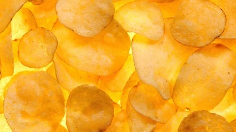 Golden potato chips rotating in 4K. | Stock Video | Pond5