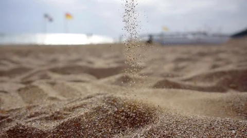 Golden sand pouring on beach. | Stock Video | Pond5
