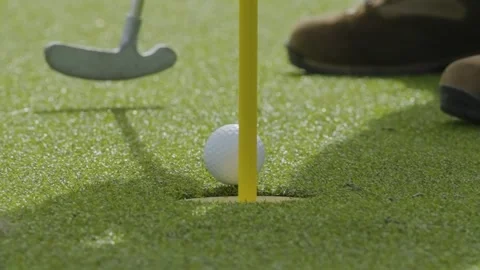 Golf ball falling in the hole in slow mo... | Stock Video | Pond5
