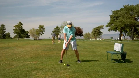 Golfer driving the golf ball at the driv... | Stock Video | Pond5