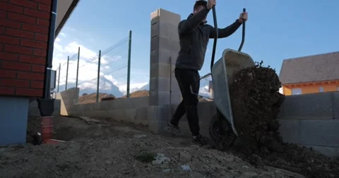 Good looking man worker throwing earth a... | Stock Video | Pond5