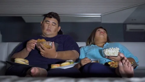 Gorged fat couple looks sleepy on the be... | Stock Video | Pond5