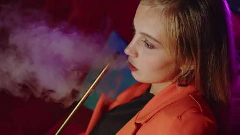 Gorgeous blonde woman smoking hookah sit... | Stock Video | Pond5