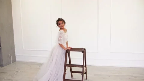 Gracefully leaning on a stand, a girl in... | Stock Video | Pond5