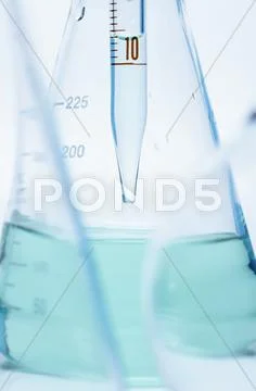 Graduated pipette dropping liquid into Erlenmeyer flask Stock Photo ...