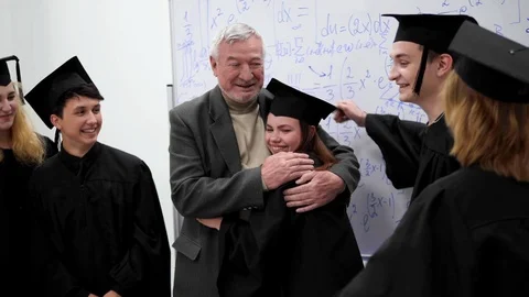 Graduates hug with their professor in un... | Stock Video | Pond5