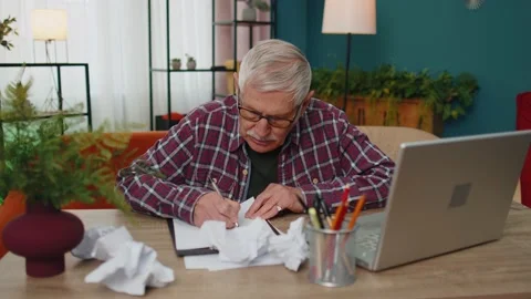 Grandfather working on laptop man writin... | Stock Video | Pond5