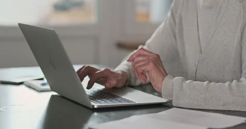 Grandma is typing on her laptop. Close-u... | Stock Video | Pond5