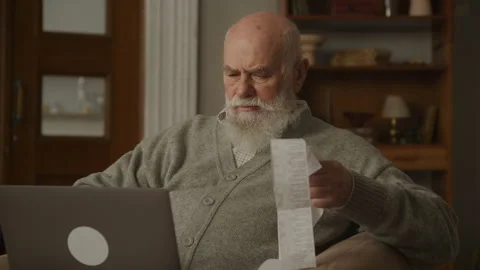 Grandpa Checking Expenses and Using Lapt... | Stock Video | Pond5