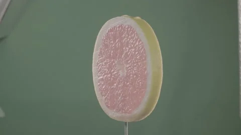 Grapefruit rotating with loop on green s... | Stock Video | Pond5