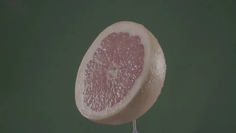 Grapefruit rotating with loop on green s... | Stock Video | Pond5