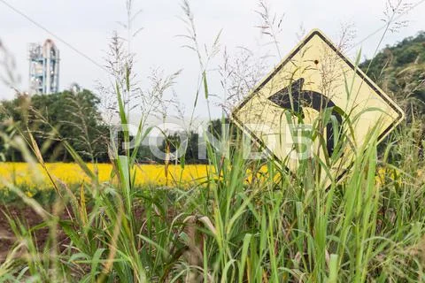 Grass overlay traffic Signs turn left and factory background Stock ...