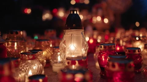 Grave candles lights glowing on cemetery... | Stock Video | Pond5