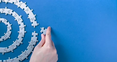 Gray circular puzzles stacked on blue ba... | Stock Video | Pond5