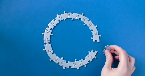Gray circular puzzles stacked on blue ba... | Stock Video | Pond5
