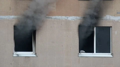 Gray thick smoke billows from two window... | Stock Video | Pond5