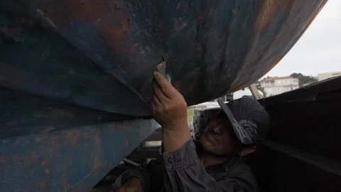 Greek fisherman flakes off old mastic se... | Stock Video | Pond5