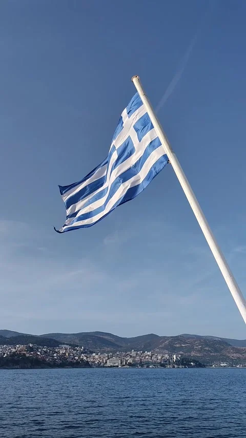 Greek flag waving on the wind with sea i... | Stock Video | Pond5